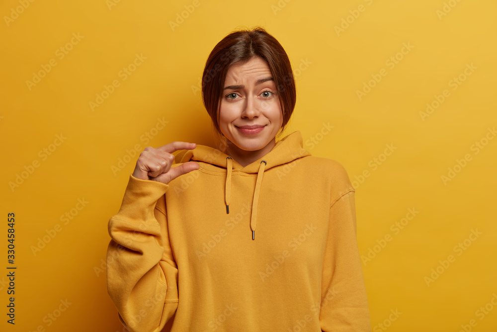 Pretty young European woman shows small size, demonstrates tiny measure ...