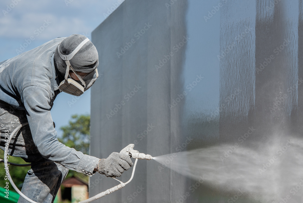 Airless Spray Painting, Worker painting on steel wall surface by ...
