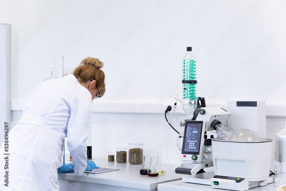 Chemist in laboratory controls chemical process with tablet Stock Photo ...