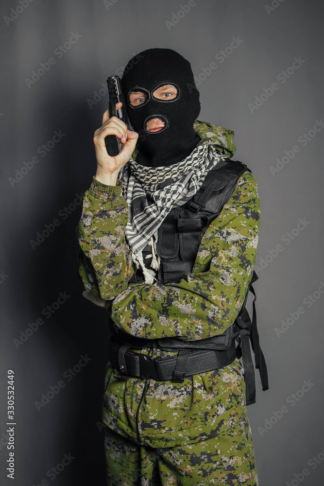 A member of the special police squad, takes aim, holds a pistol ...