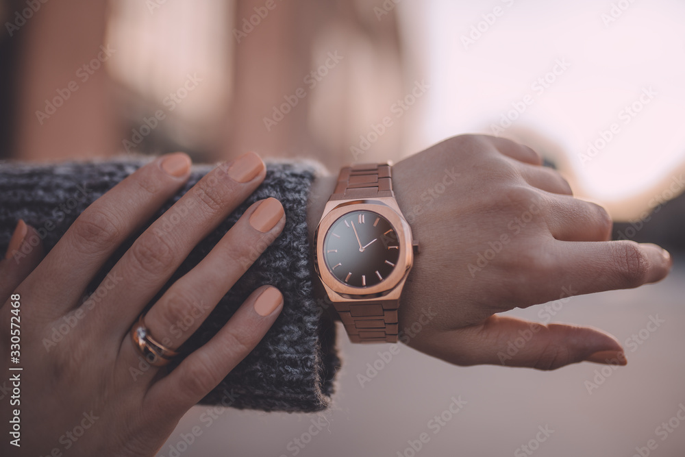 Stylish rose gold watch on woman hand, close-up. Stock Photo | Adobe Stock