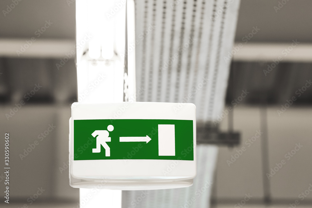 Fire exit sign in building Stock Photo | Adobe Stock