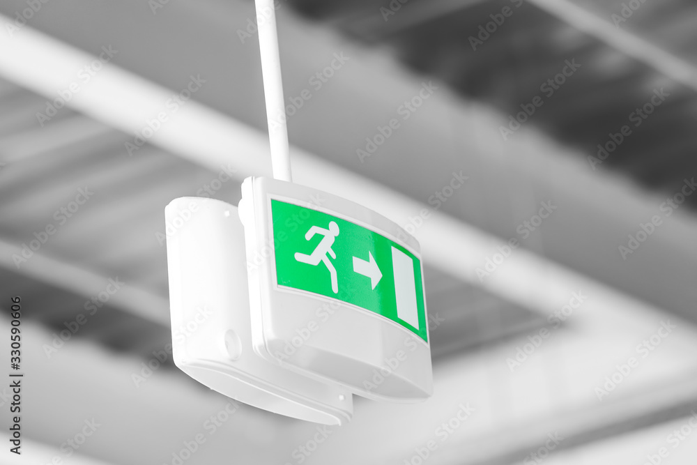 Fire exit sign in building Stock Photo | Adobe Stock