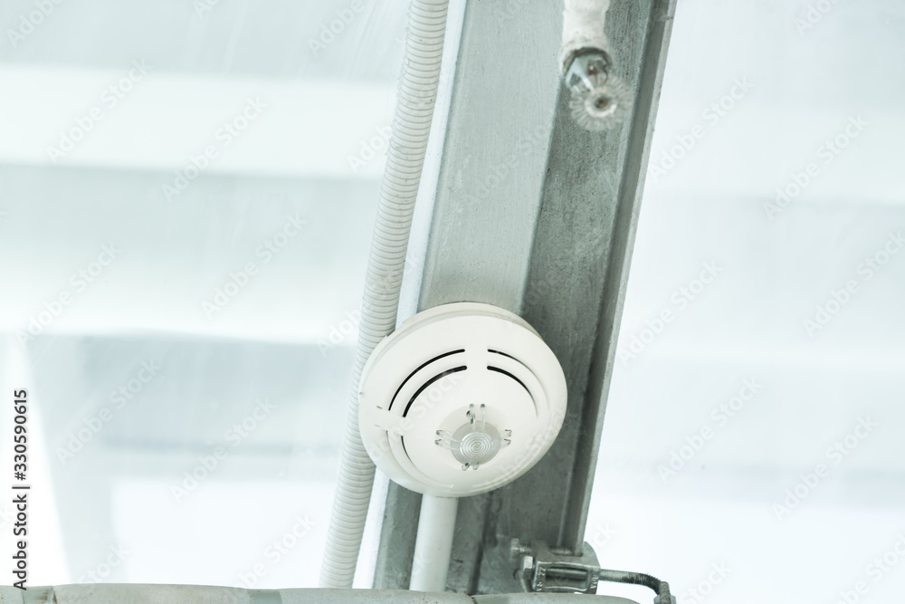 Modern smoke detector with fire extinguishing system on ceiling Stock ...