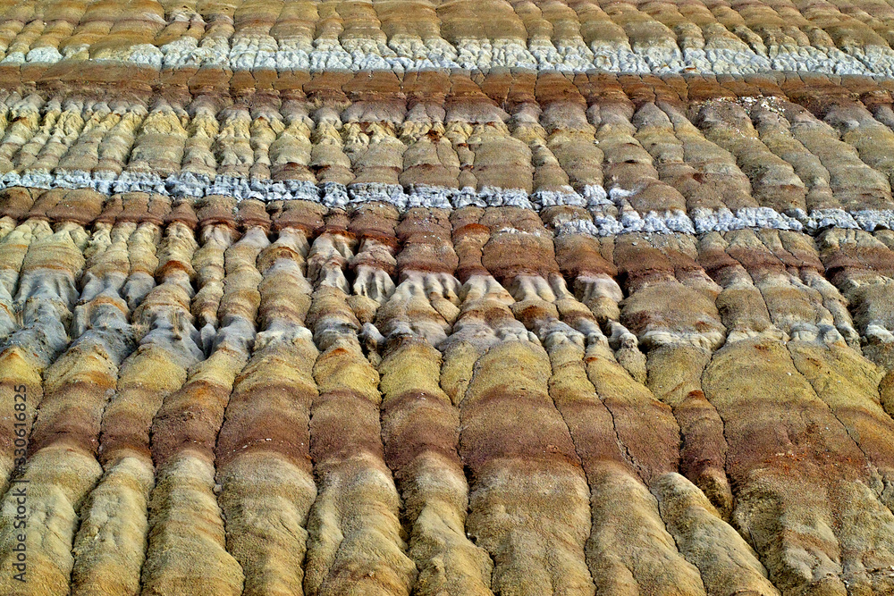 Volcaniclastic outcrop erosion abstract. Large roadcut of pyroclastic ...