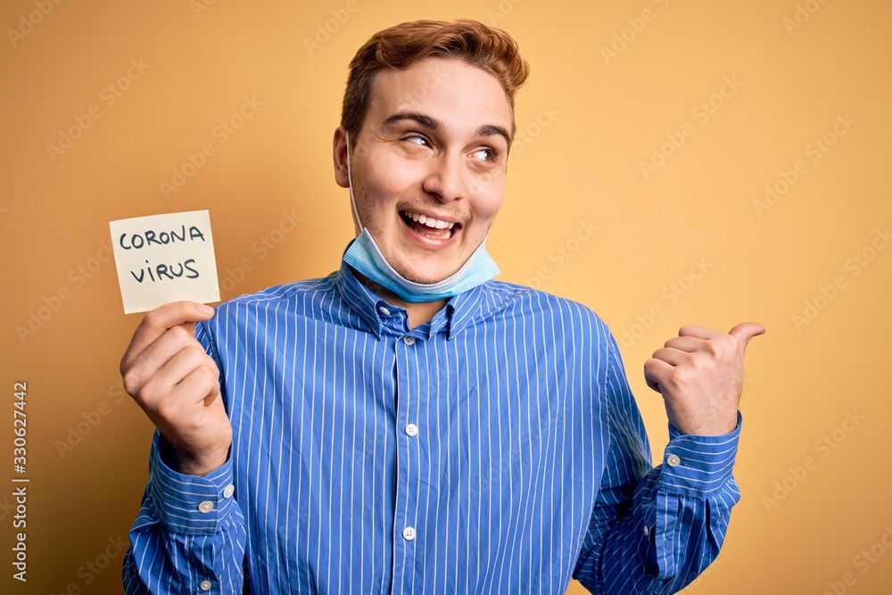 Young man wearing medical security mas holding paper note reminder with ...