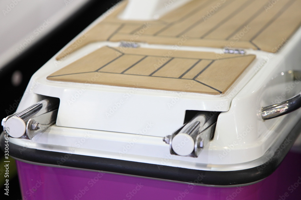 Gray marine teak motor yacht transom with folded ladder on stern deck ...