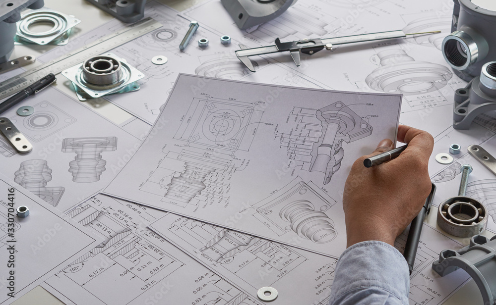 Engineer technician designing drawings mechanical parts engineering ...