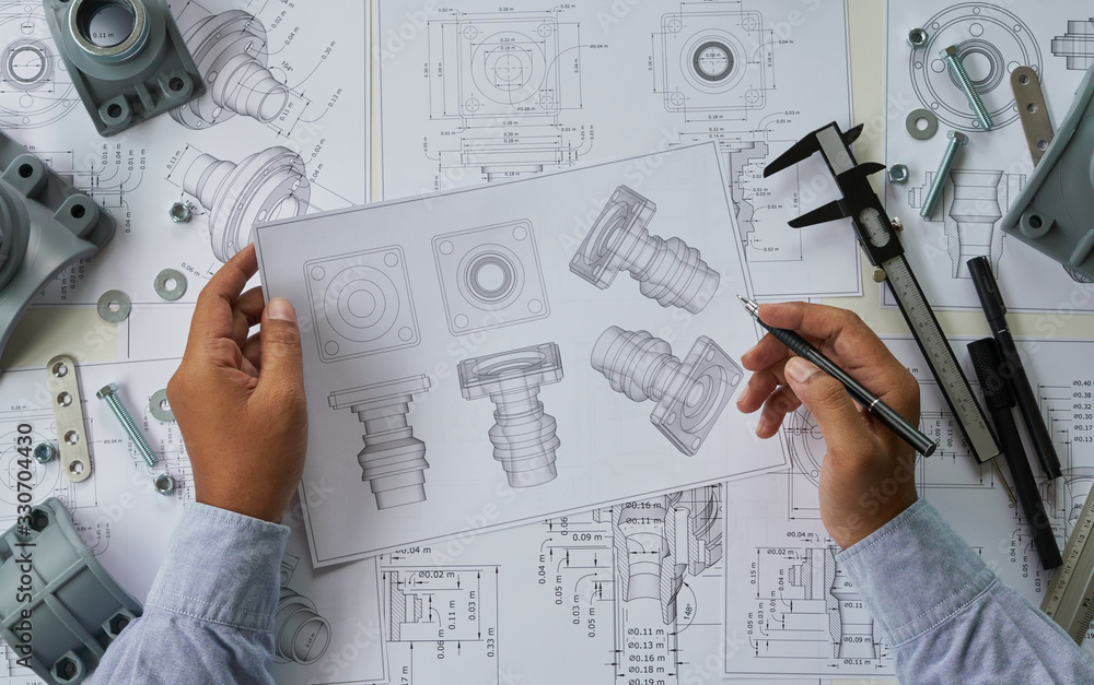 Engineer technician designing drawings mechanical parts engineering ...