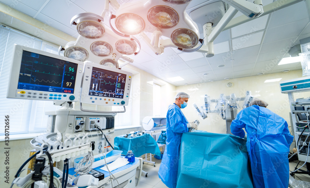 Process of trauma surgery operation. Group of surgeons in operating ...