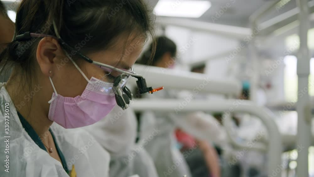 Doctors in mobile triage unit wearing face masks to treat patients ...