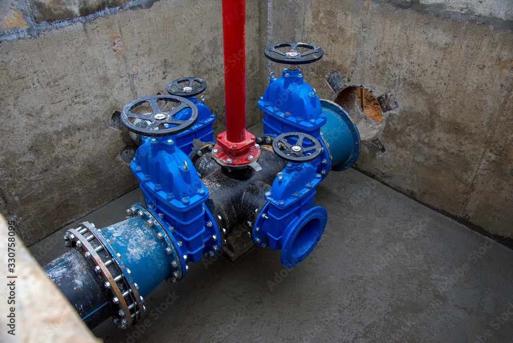 Gate valves in valve pit of the underground piping networks. Laying ...