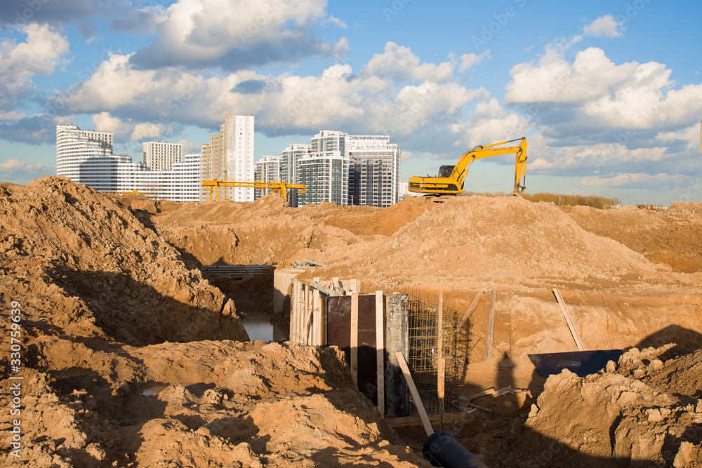 Laying of underground storm sewer pipes in ditch. Installation of water ...