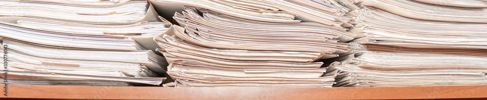 Old paper documents stacked in archive. Documents on the shelves of ...