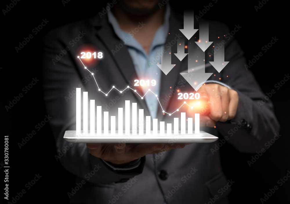 Businessman hand point drawing decrease trend arrow for economic crisis ...