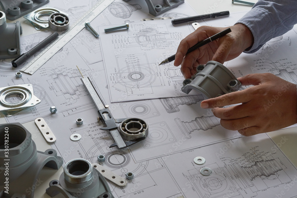 Engineer technician designing drawings mechanical parts engineering ...
