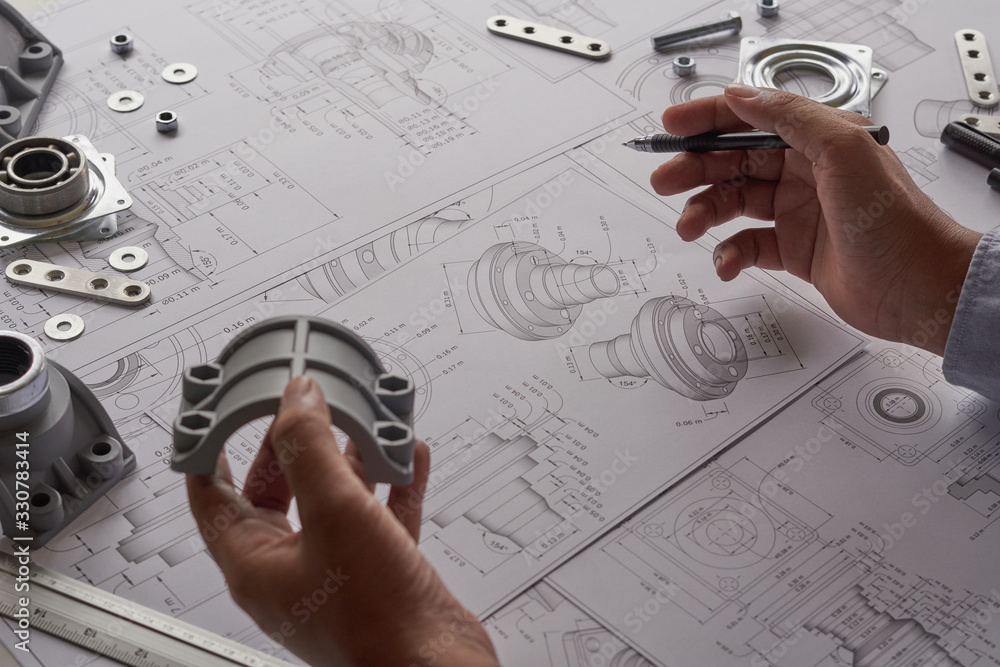 Engineer technician designing drawings mechanical parts engineering ...