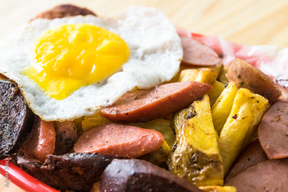 Peruvian salchipapa: hot dog with fried egg and potatoes Stock Photo ...