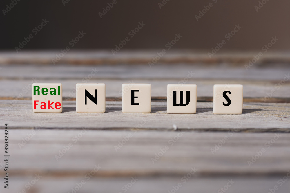 Real fact or fake news concept words on tiles on brown rustic ...