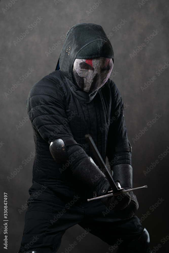 A man in a scary mask with a beard with a skid swords. Historical ...