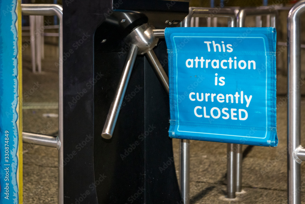 Sign at amusement/theme park attraction turnstile entrance: "This ...