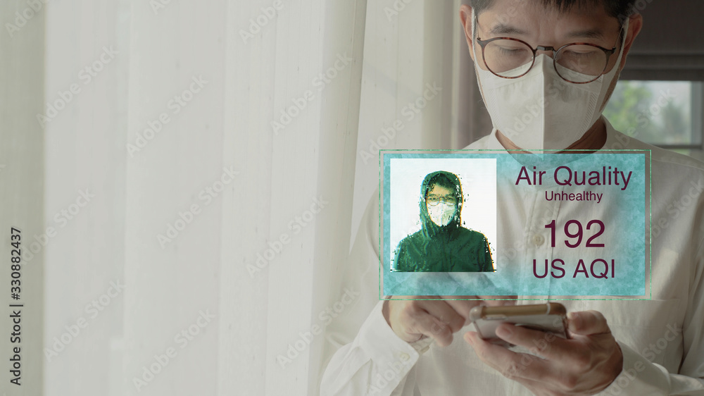 Asian man wearing surgical mask checking mobile application for Air ...
