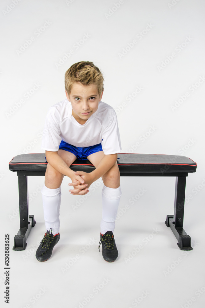 soccer boy sitting on bench Stock Photo | Adobe Stock