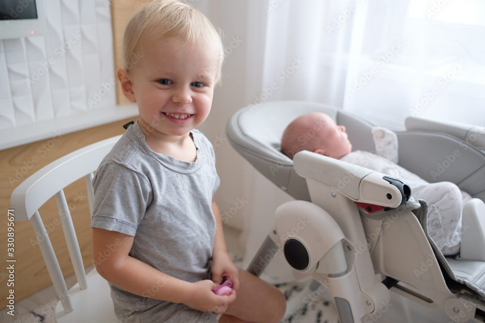 Little brother hugging her newborn baby. Toddler kid meeting new ...