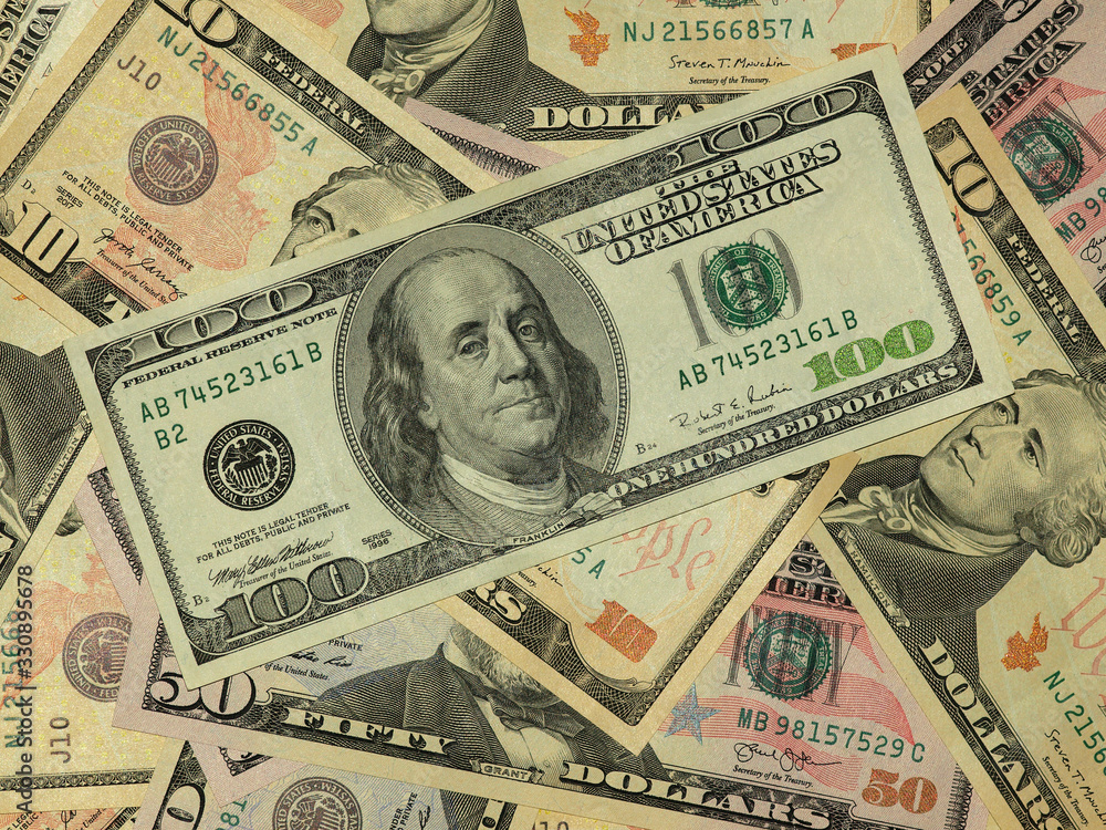 Colorful background with money US dollars of different value. Top view ...