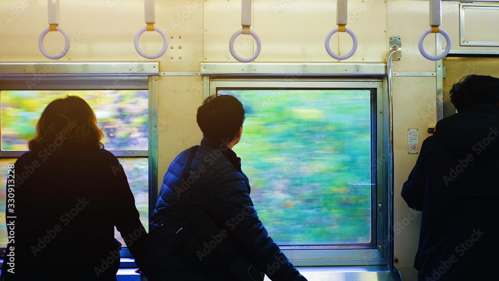 Bank view of Traveler tourist man and woman in the train looking out to ...
