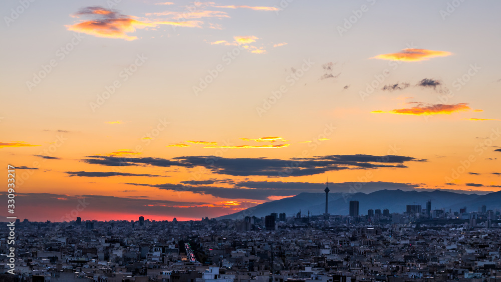 Tehran skyline at the sunset with Milad tower in the frame, colorful ...