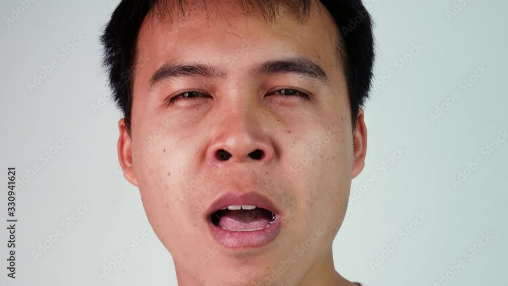 Close up portrait of tired Asian man expressing drowsy and yawn over ... Close up portrait of tired Asian man expressing drowsy and yawn over ...