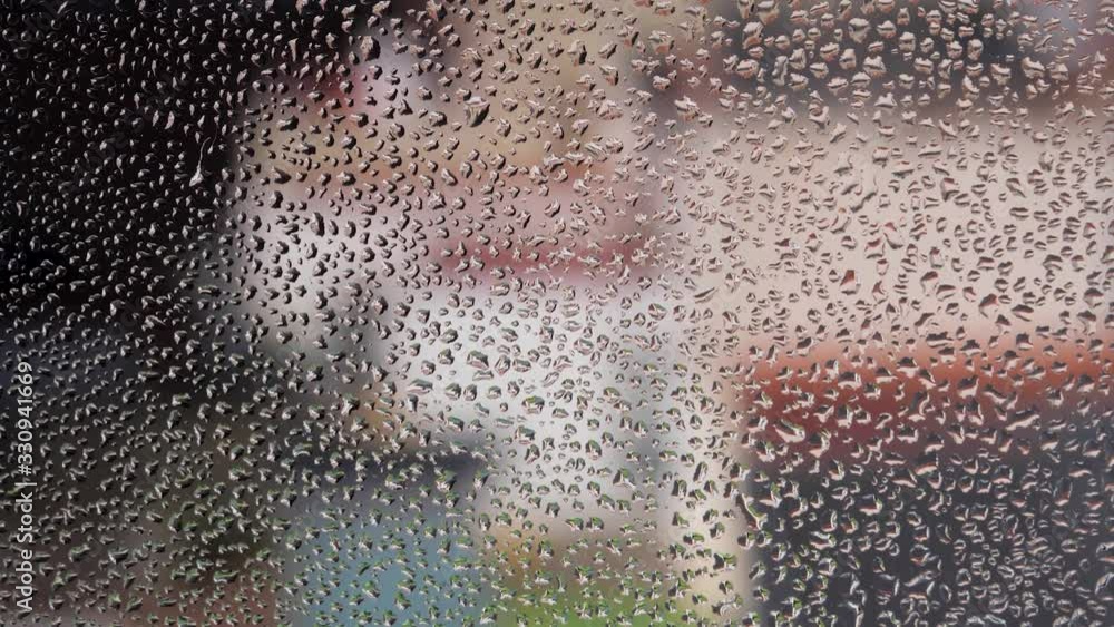 Vídeo do Stock: Misted glass of window with water drops and blurred ...