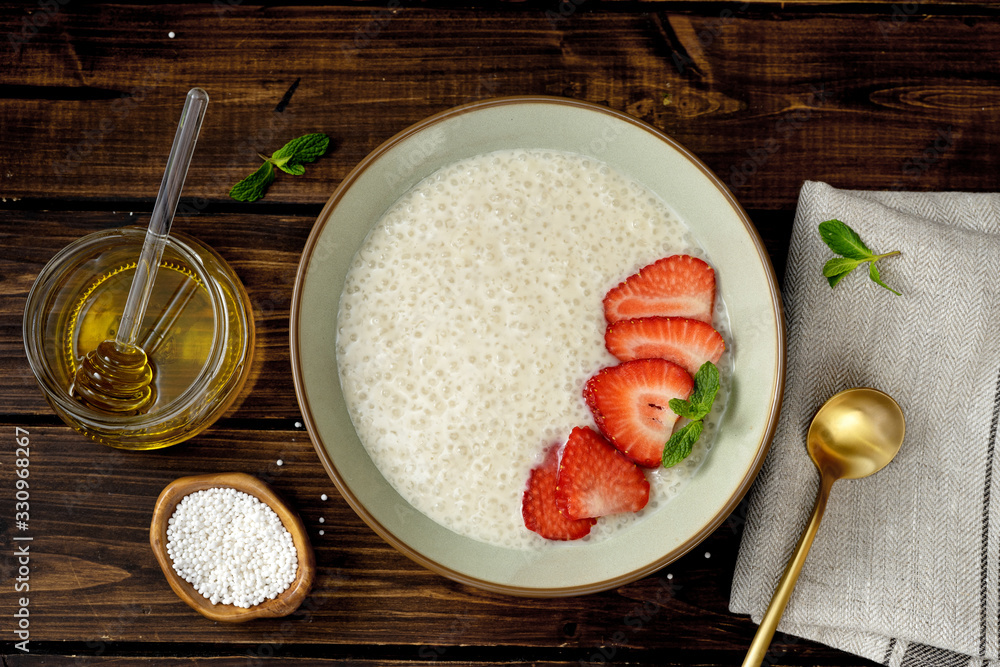 Top view of taioca pudding with plant-based milk on dark rustic ...