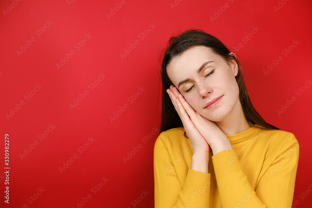 Lovely young woman with happy serene face pretends sleeping, leans on ...