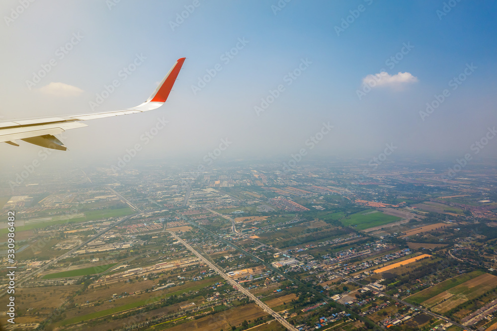 The part of airplane wing with the naturescape with sky clouds and ...