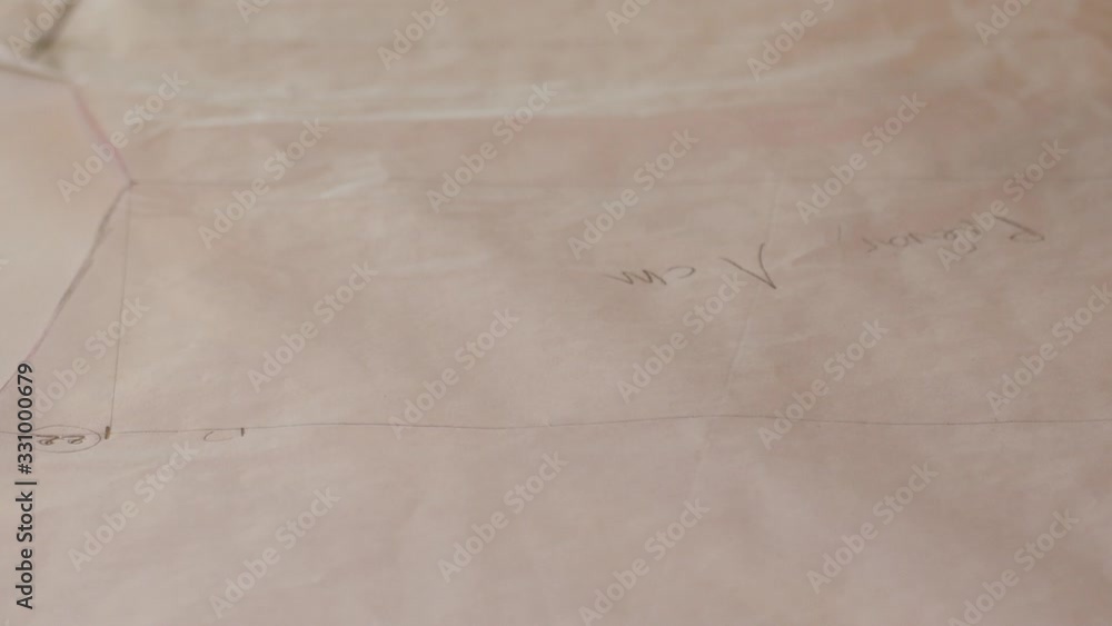 tailor reviewing patterns and hand drawings. In sewing and fashion ...
