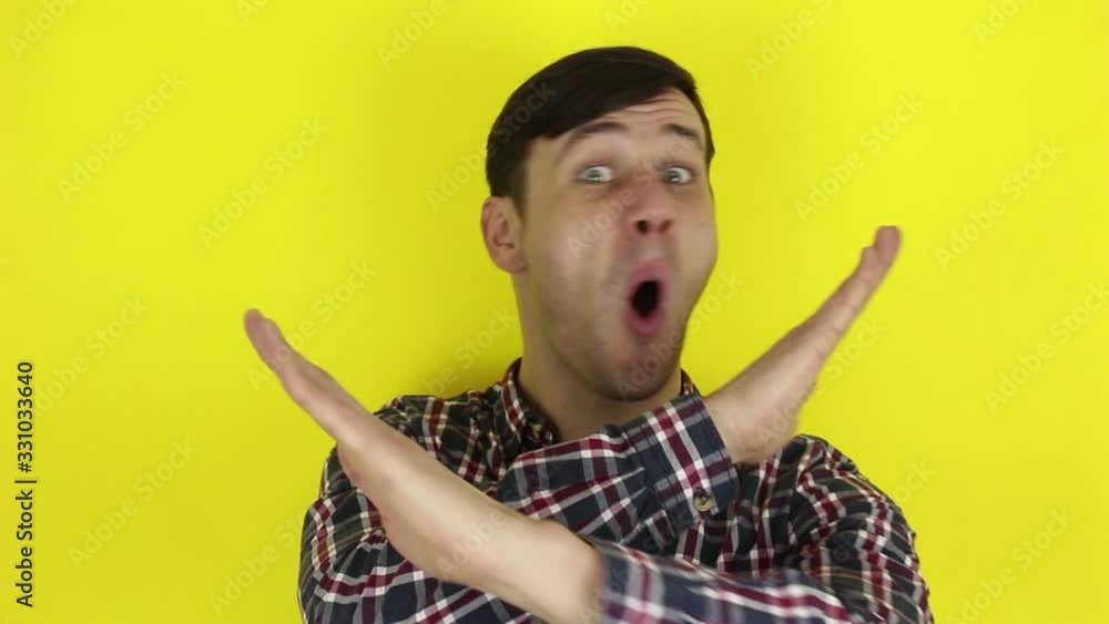 A funny, handsome guy expresses his disagreement and makes a gesture of ...