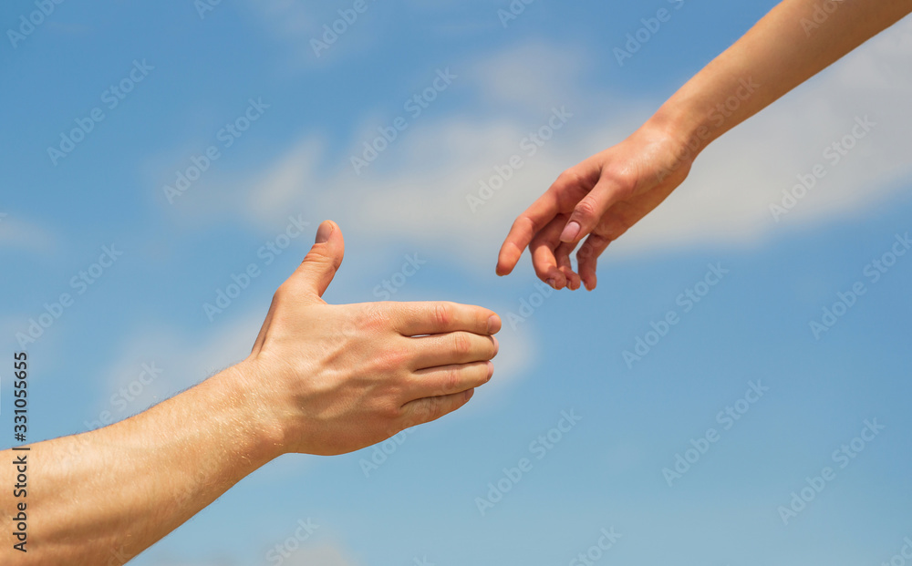 Giving a helping hand. Hands of man and woman on blue sky background ...
