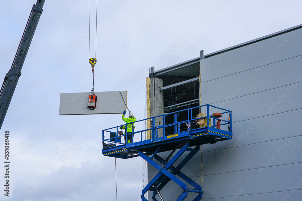 sandwich panels wall mounting using crane and scissor lift Stock Photo ...