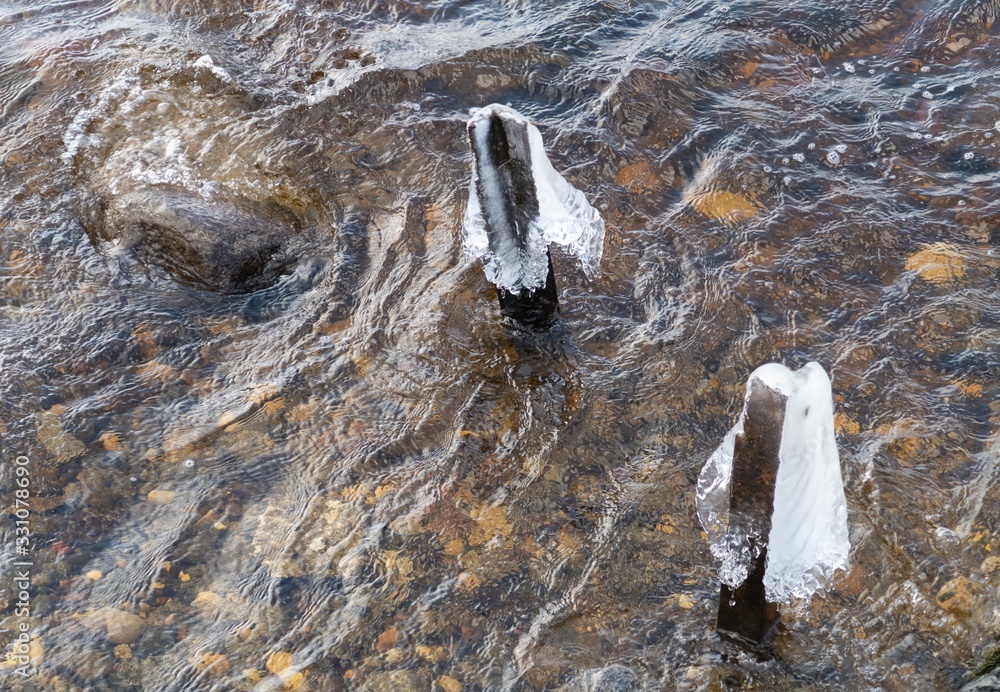 Iced metal piles of a former boat pier Stock Photo | Adobe Stock
