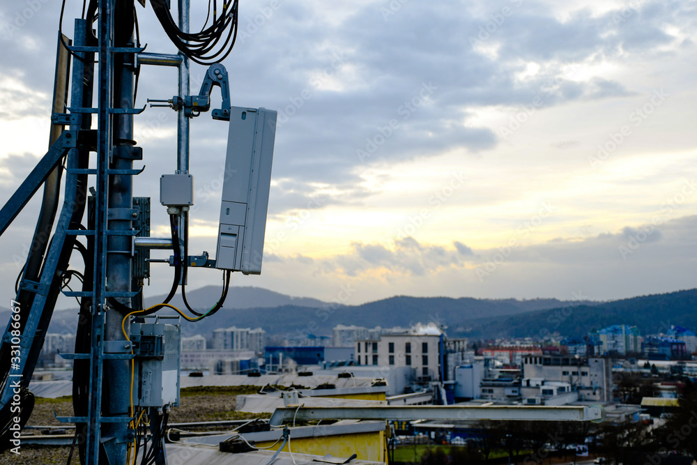 5G new radio telecommunication network antenna mounted on a metal pole ...