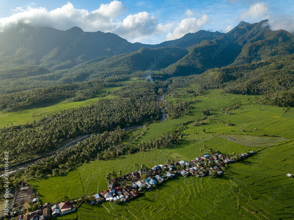Philippine countryside with rice fields and a volcano in the background ...