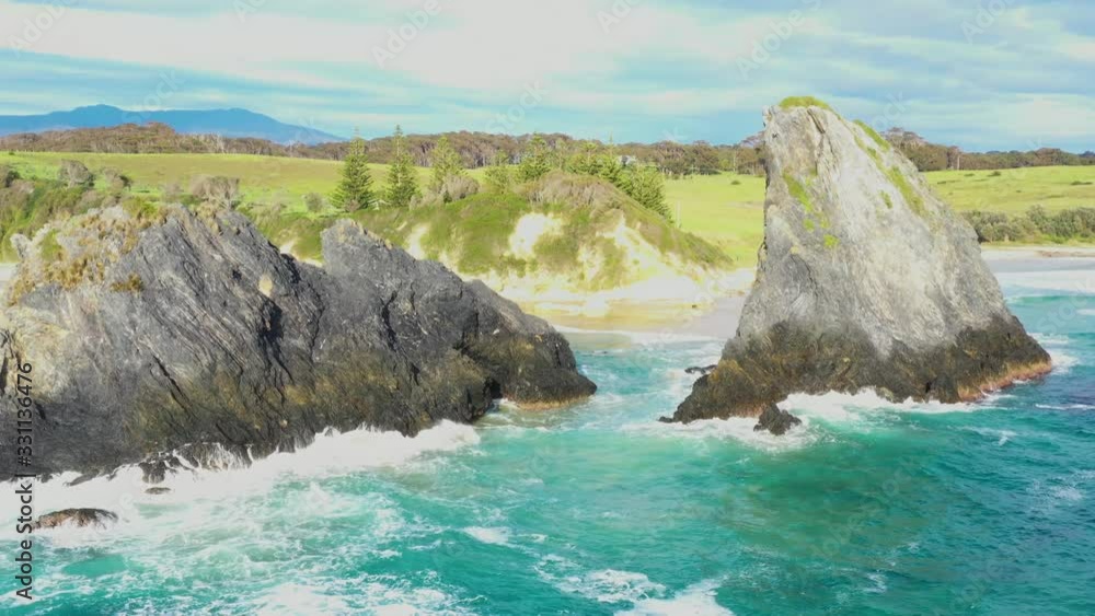 Aerial drone closeup view of Glasshouse Rocks at Narooma Beach in ...