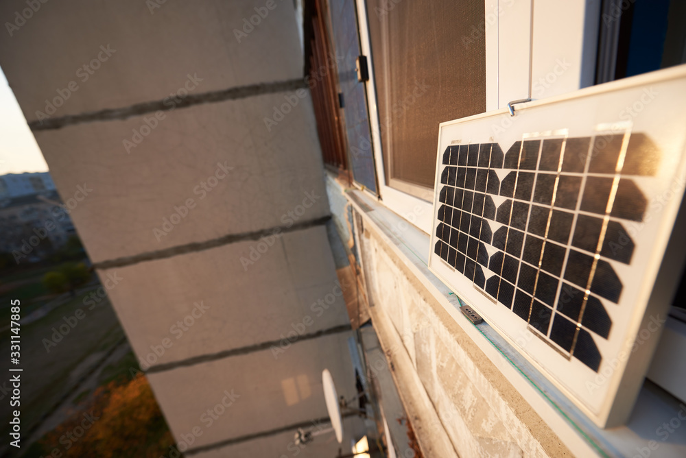 Solar panel on the window of a high-rise residential building against a ...