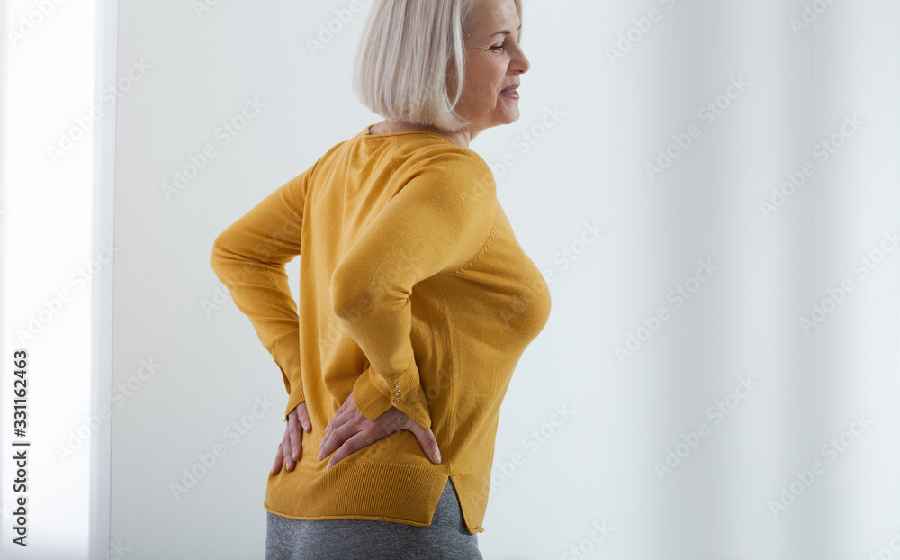 Middle aged woman with pain in the backache and lower back. Concept ...