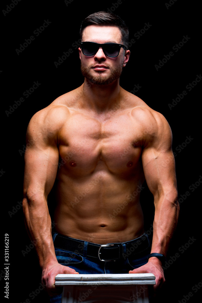 Shirtless handsome male with a perfect muscular body posing while ...