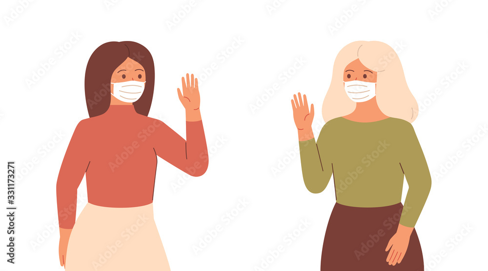 Two women in face masks maintain a social distance by greeting each ...
