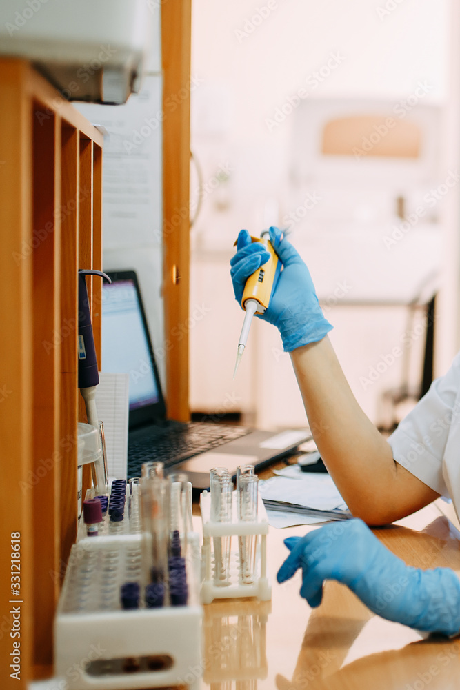 Blood test process in laboratory. Doctor hands making blood test. Many ...
