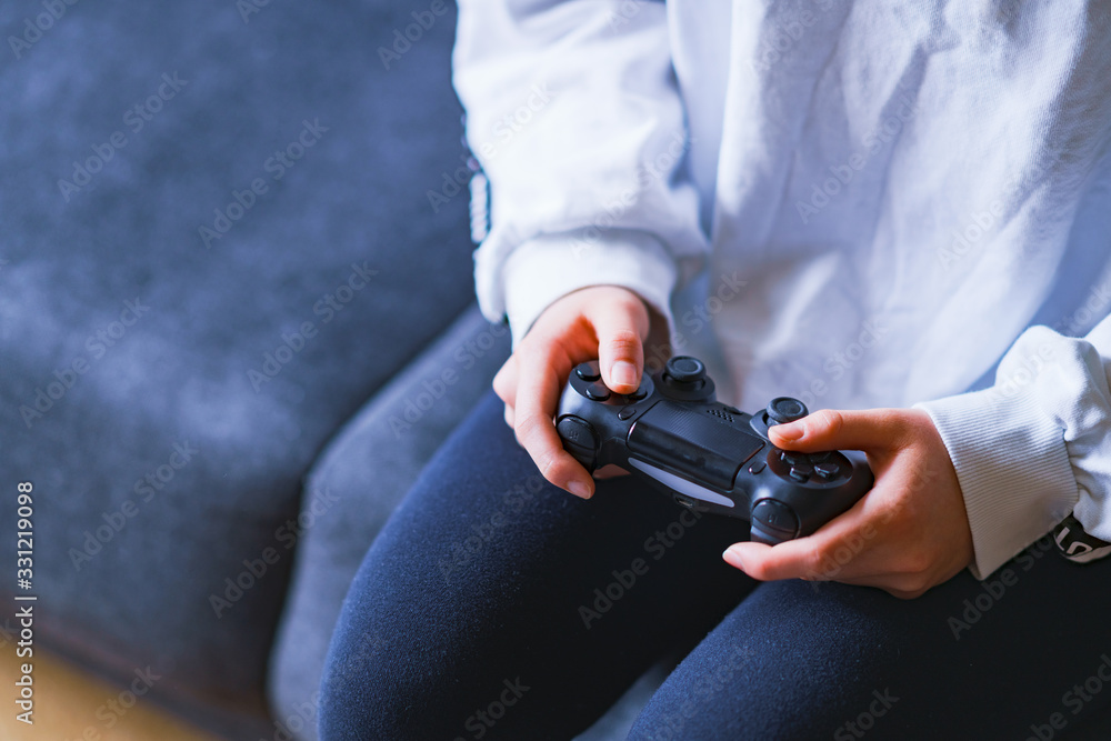 Lifestyle of Japanese girl playing game by using wireless controller ...